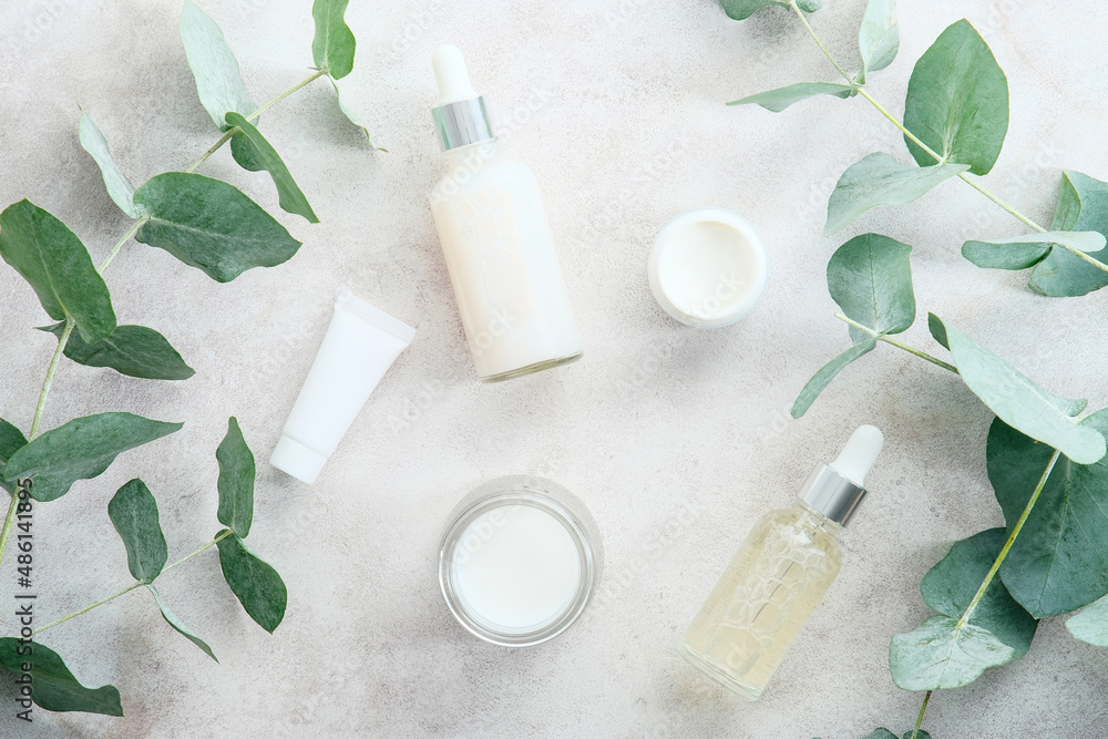 Transparent cosmetic packaging with eucalyptus leaves on stone table ...