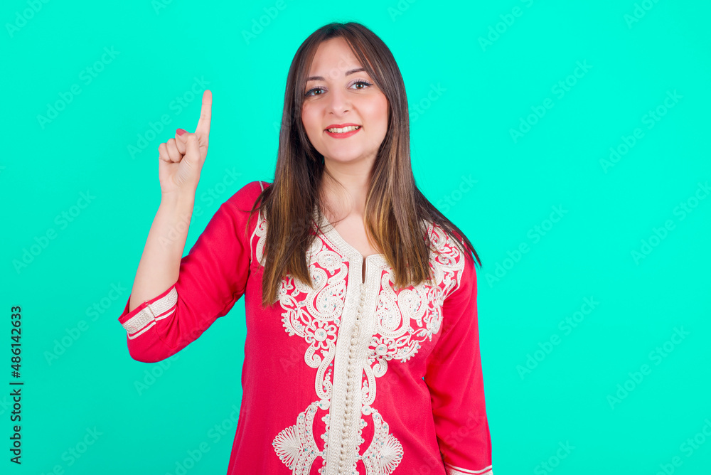 young beautiful moroccan woman wearing traditional caftan dress over ...