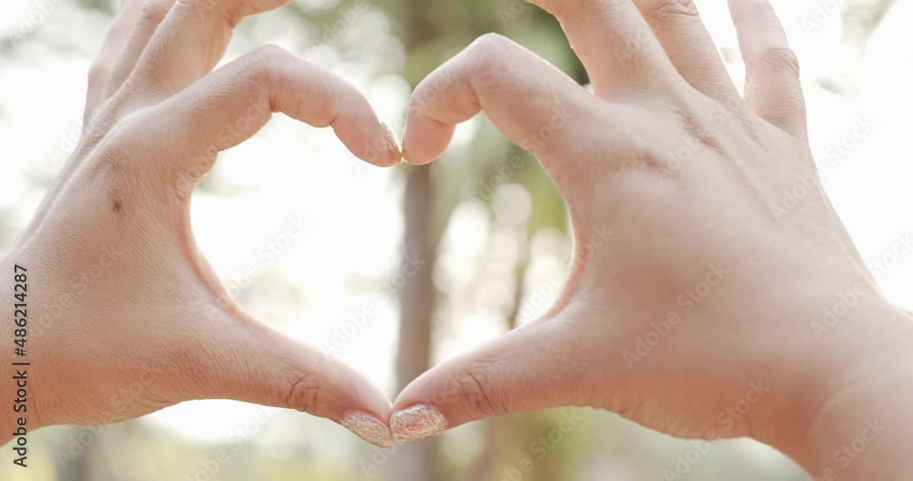 Make love symbols with hands through the sunlight. Symbol that ...
