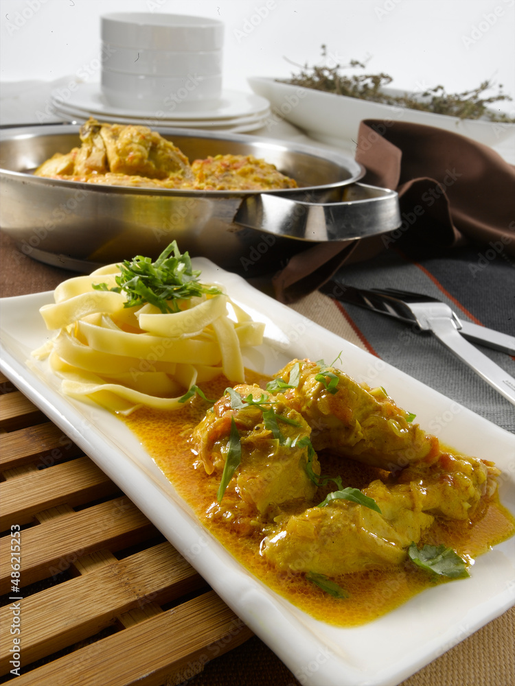 Pollo al curry con pasta. Chicken curry with pasta. Stock Photo | Adobe ...