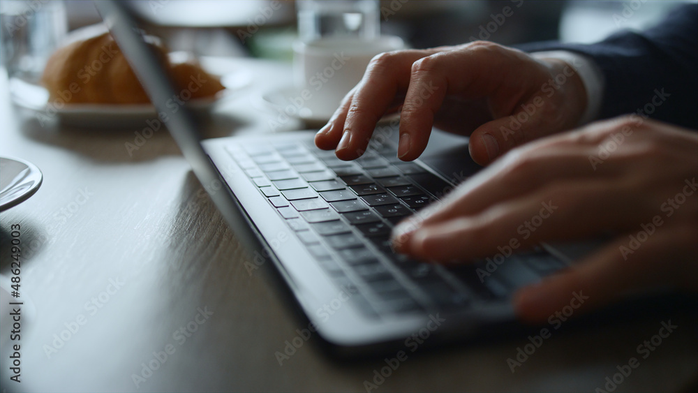 Businessman hands working laptop typing computer keyboard in cafe ...