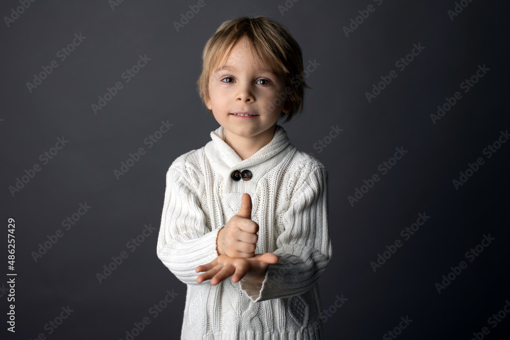 Cute little toddler boy, showing HELP gesture in sign language on gray ...