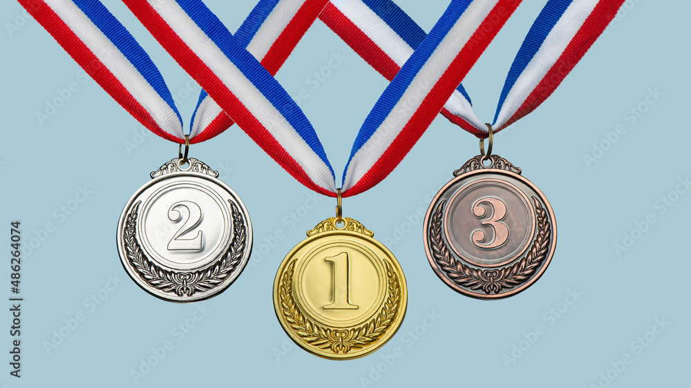 collection gold, silver, bronze medal against blue sky. award and ...