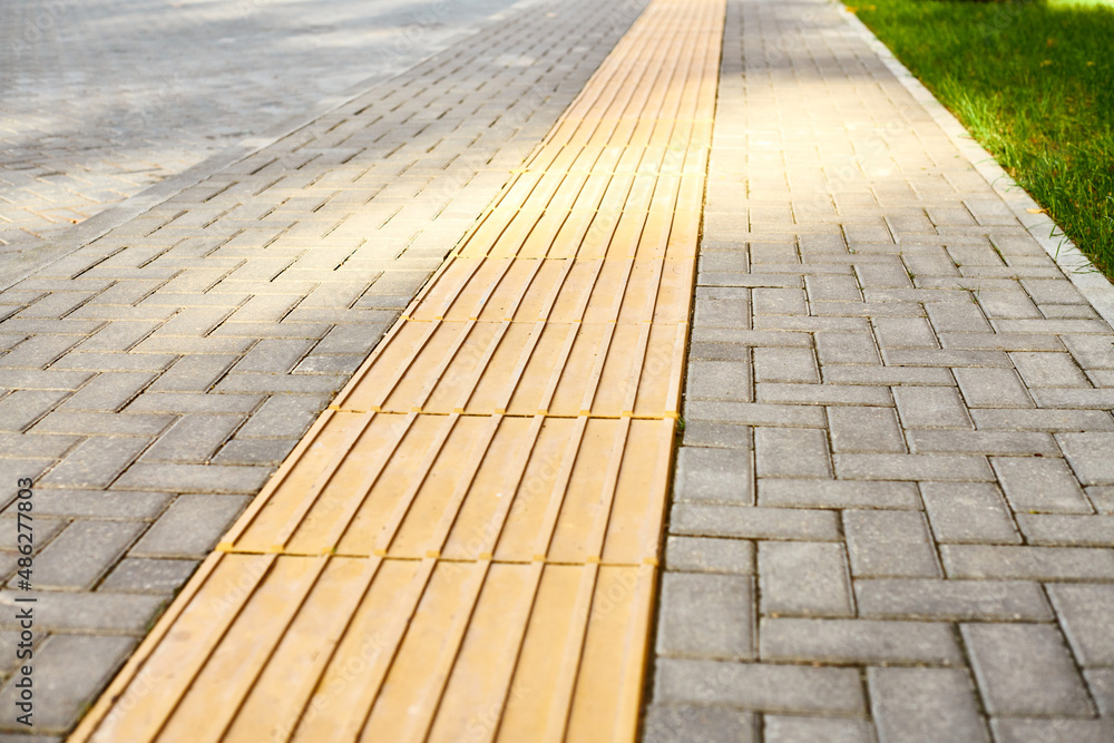 Yellow tactile paving on walkway, tactile ground surface indicators for ...