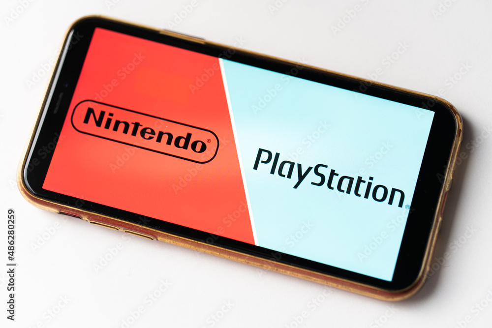 Nintendo vs Playstation logos on smartphone screen. Nintendo Switch vs ...