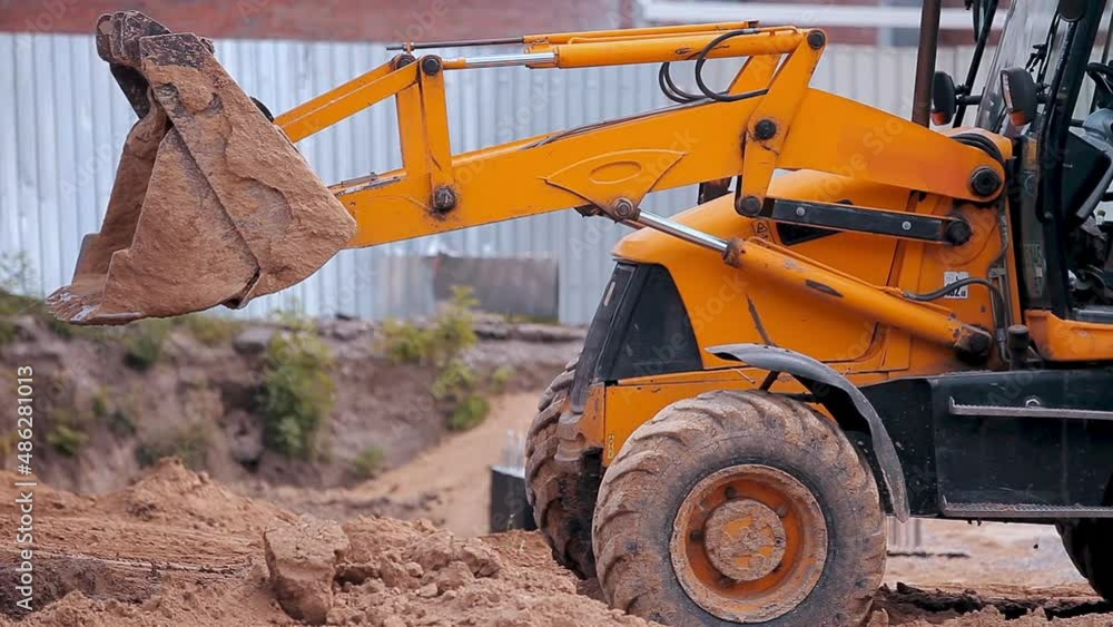 Yellow tractor on a construction site. Professional construction ...