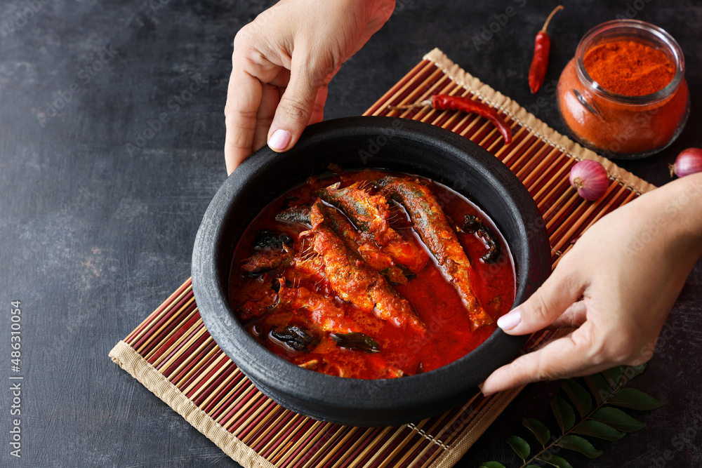 Sardine fish curry hot spicy Kerala masala fish curry rice India woman ...