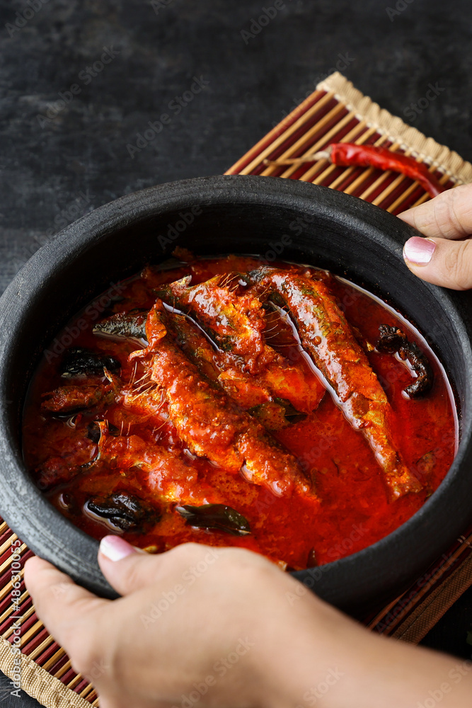 Sardine fish curry hot spicy Kerala masala fish curry rice India woman ...