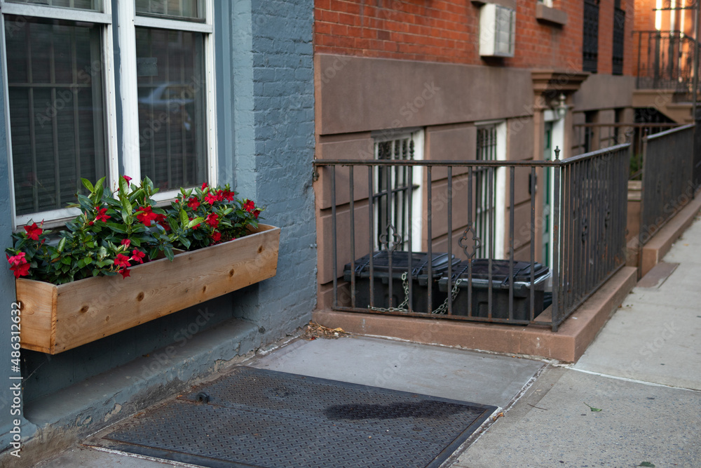 Window Sill Flower Box on a Colorful Brick Building along the Sidewalk ...
