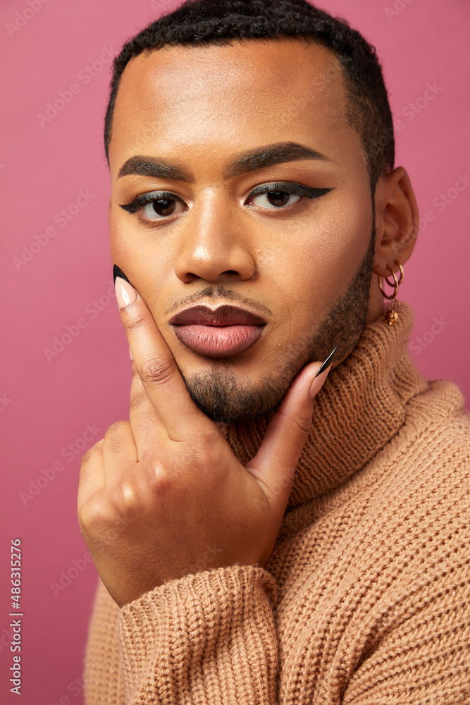 Studio portrait of queer man against purple background Stock Photo ...