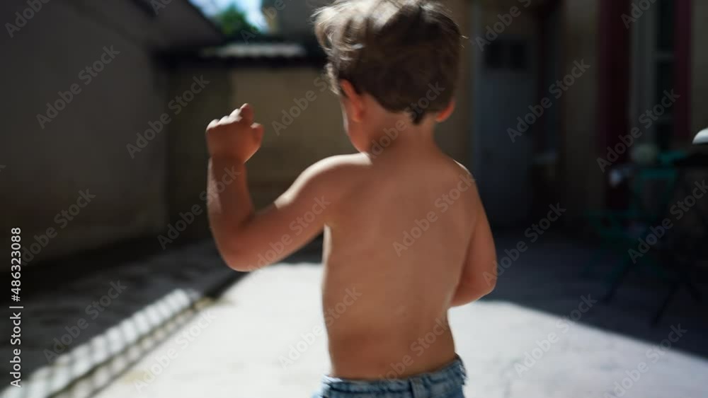Back of child running shirtless outside little boy runs Stock Video ...