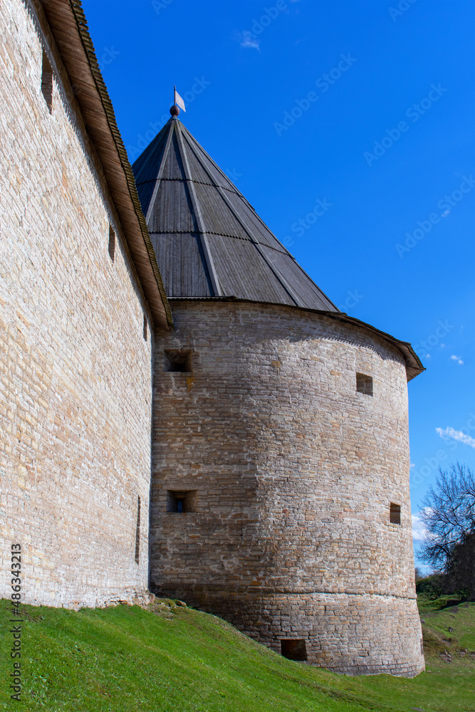 Round fortress tower with loopholes at the junction with the fortress ...