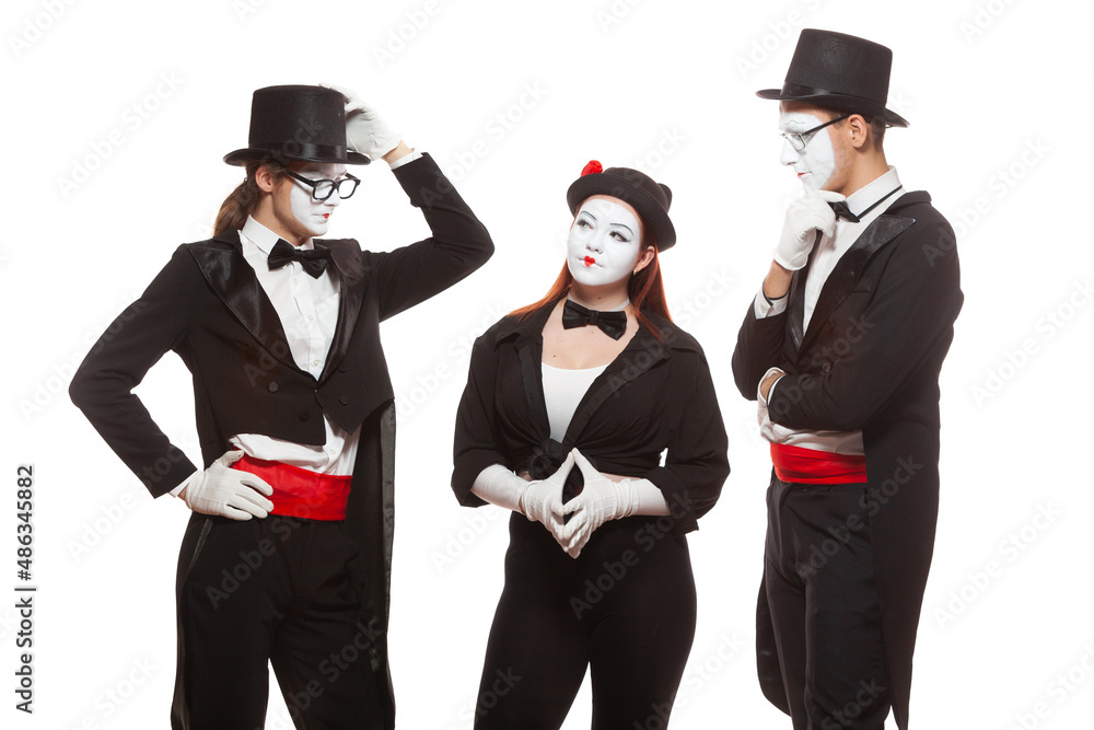 Portrait of three mime artists performing, isolated on white background ...