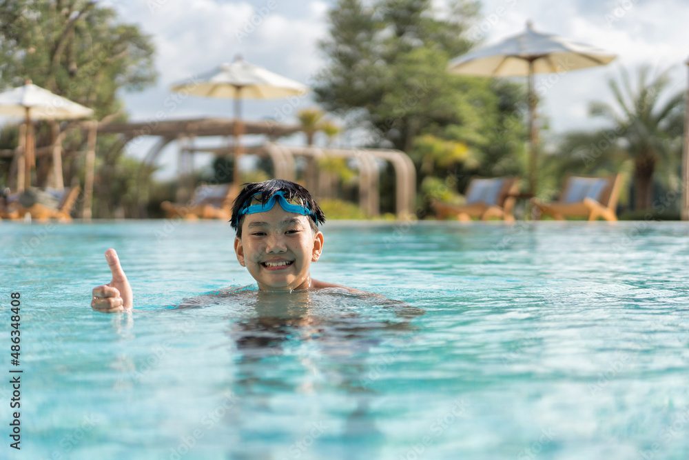 Asian Young Boy Having a good time in swimming pool, He Jumping and ...