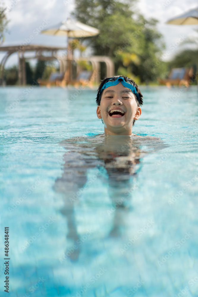 Asian Young Boy Having a good time in swimming pool, He Jumping and ...