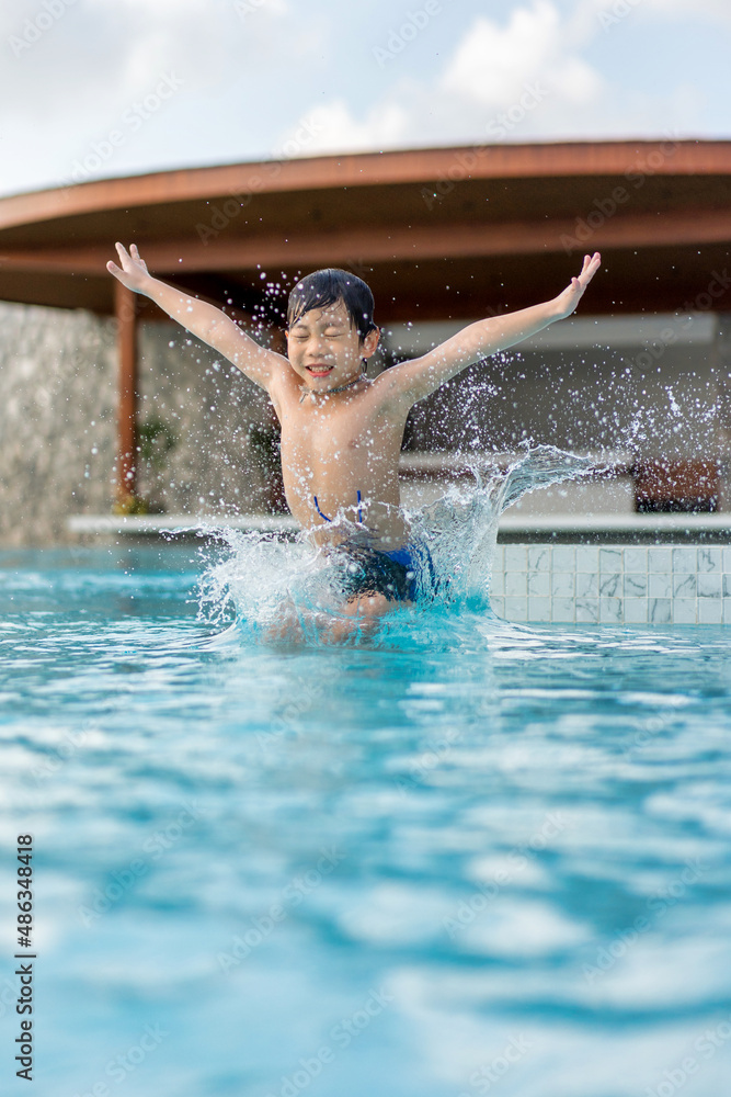 Asian Young Boy Having a good time in swimming pool, He Jumping and ...