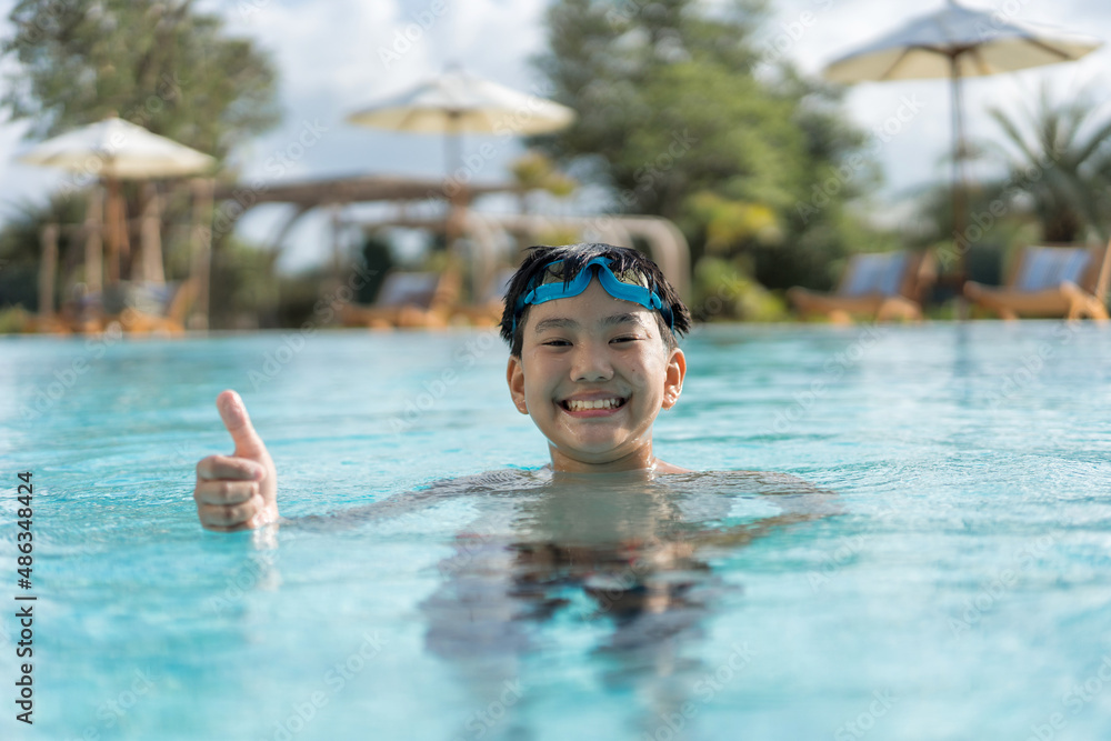 Asian Young Boy Having a good time in swimming pool, He Jumping and ...