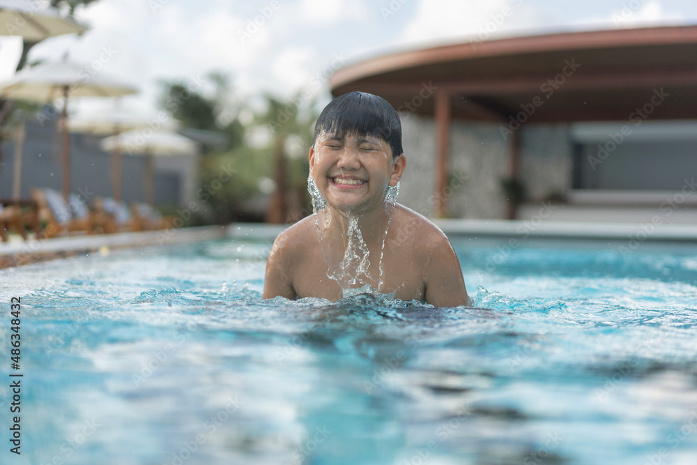 Asian Young Boy Having a good time in swimming pool, He Jumping and ...