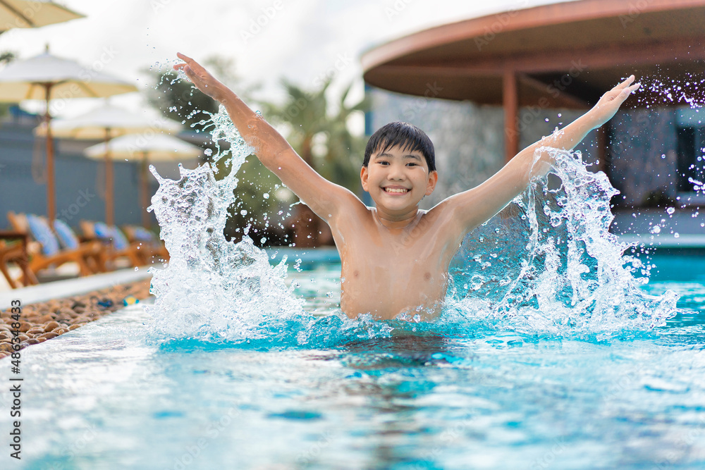 Asian Young Boy Having a good time in swimming pool, He Jumping and ...