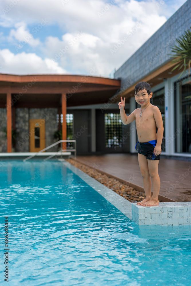 Asian Young Boy Having a good time in swimming pool, He Jumping and ...