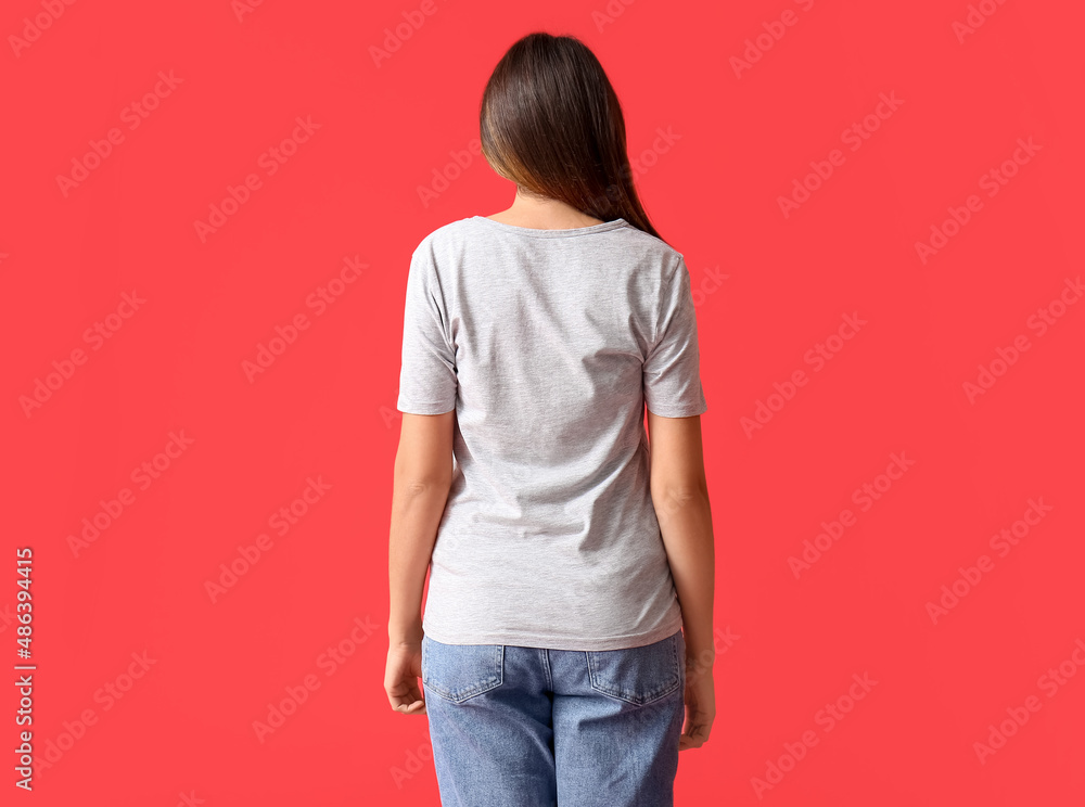 Young woman in blank t-shirt on color background, back view Stock Photo ...