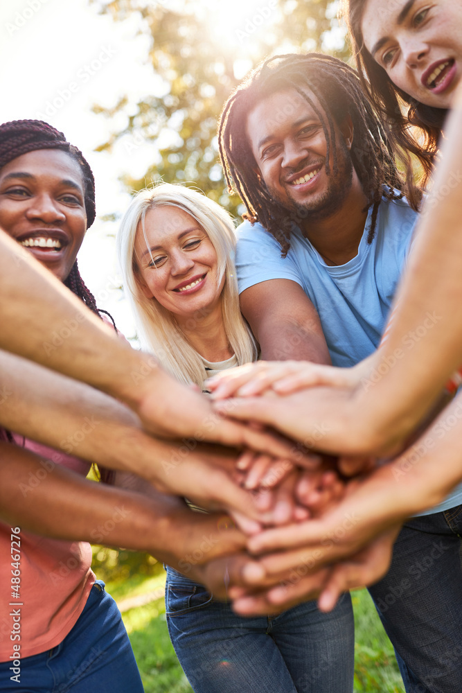 Happy start-up team stacking hands Stock Photo | Adobe Stock