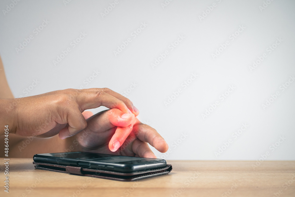 The man uses a mobile phone. Then his fingers pain. Office syndrome ...