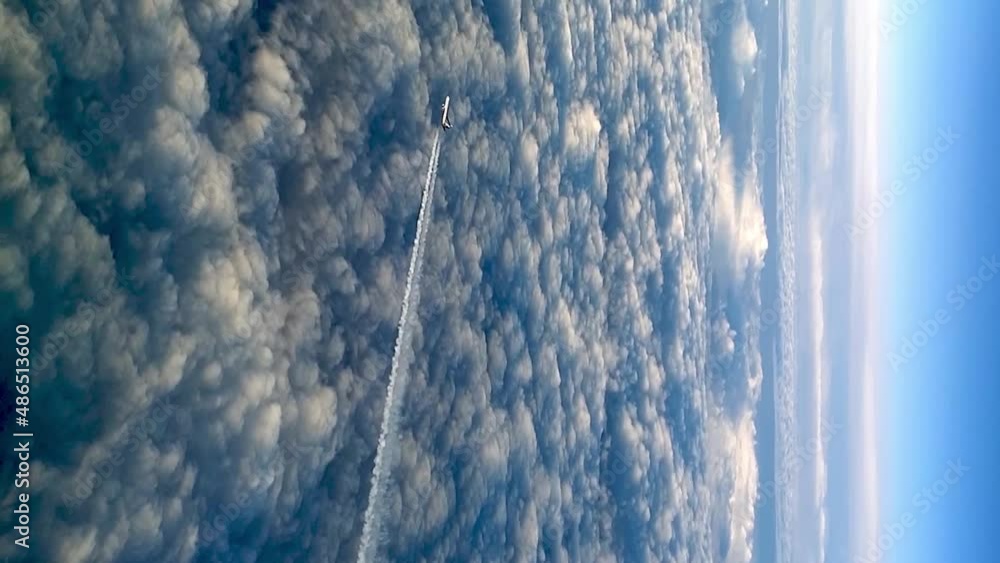 Stunning view from cockpit of flying airplane above clouds leaving long ...