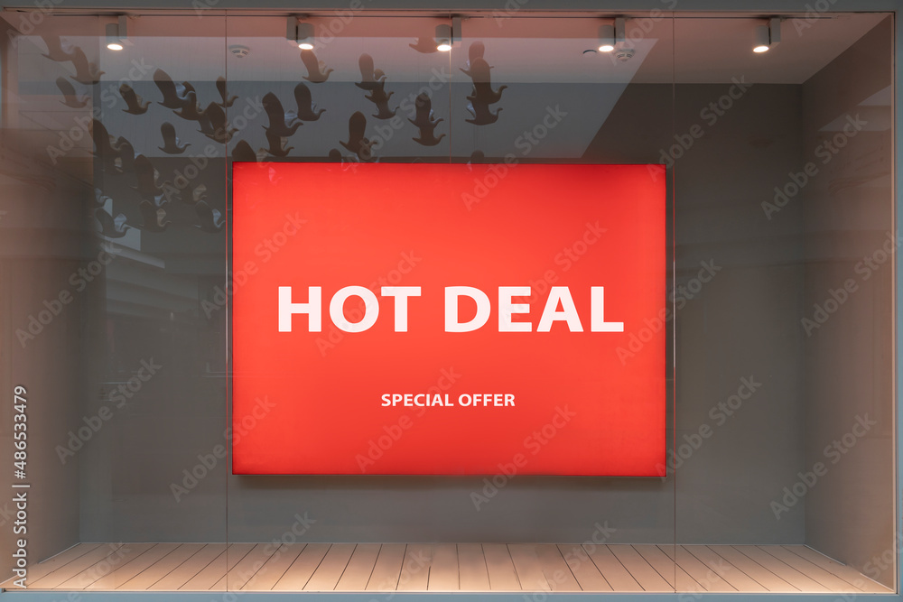 hot deal - red banner in the window window of a supermarket boutique ...