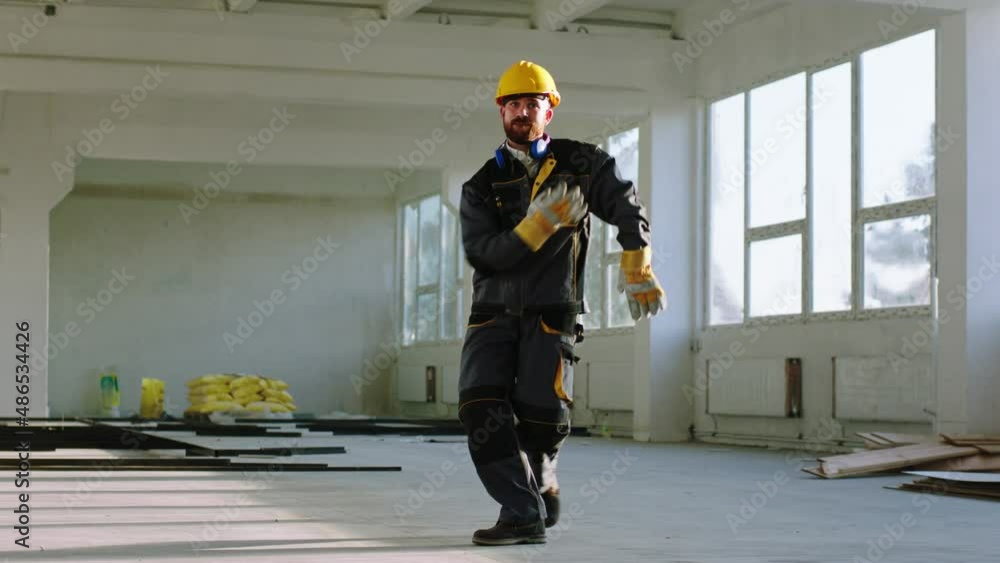 Dancing excited and charismatic man architect at the end of the day he ...