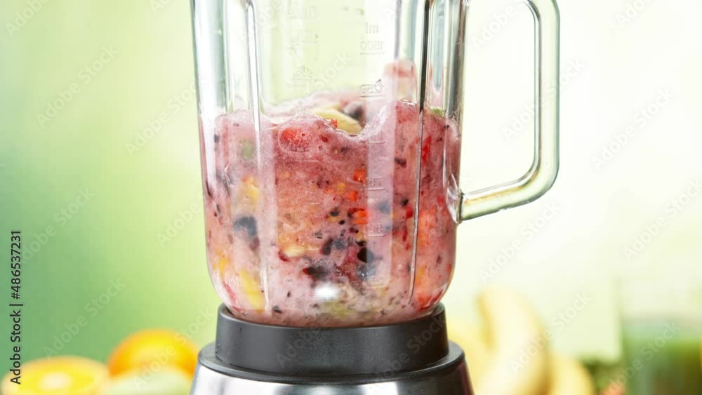 Super slow motion of mixing pieces of fruits in blender. Filmed on high ...