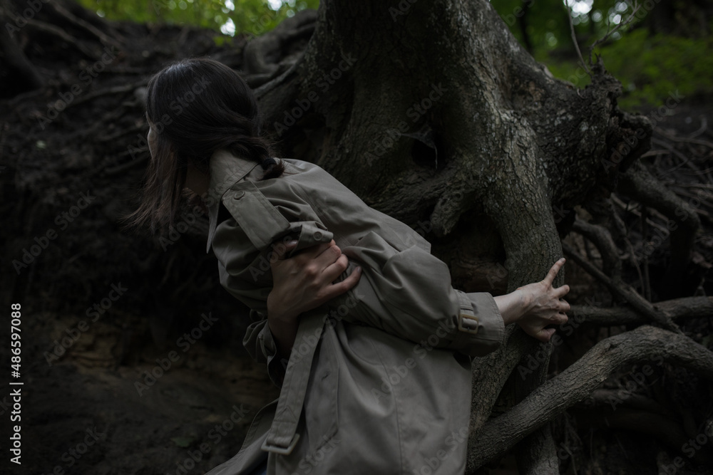 the man in the coat by the tree Stock Photo | Adobe Stock