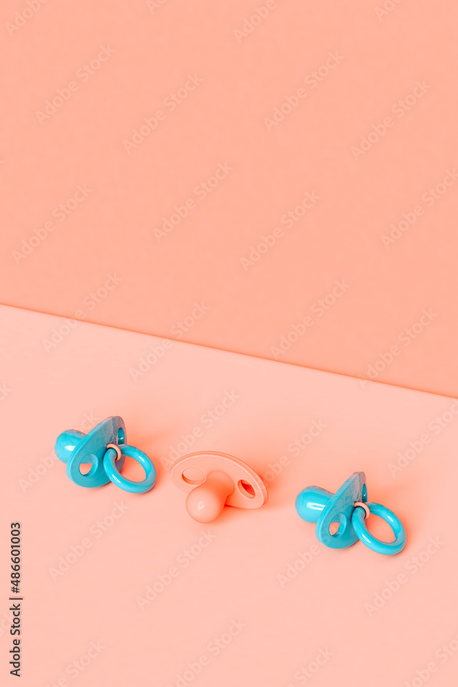 child care concept. pacifiers in pastel colors. Stock Photo | Adobe Stock