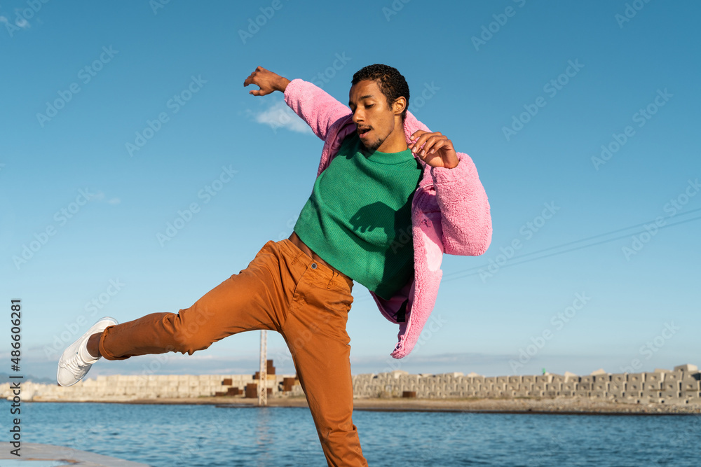 Portrait of fashion young man dancing outdoors Stock Photo | Adobe Stock