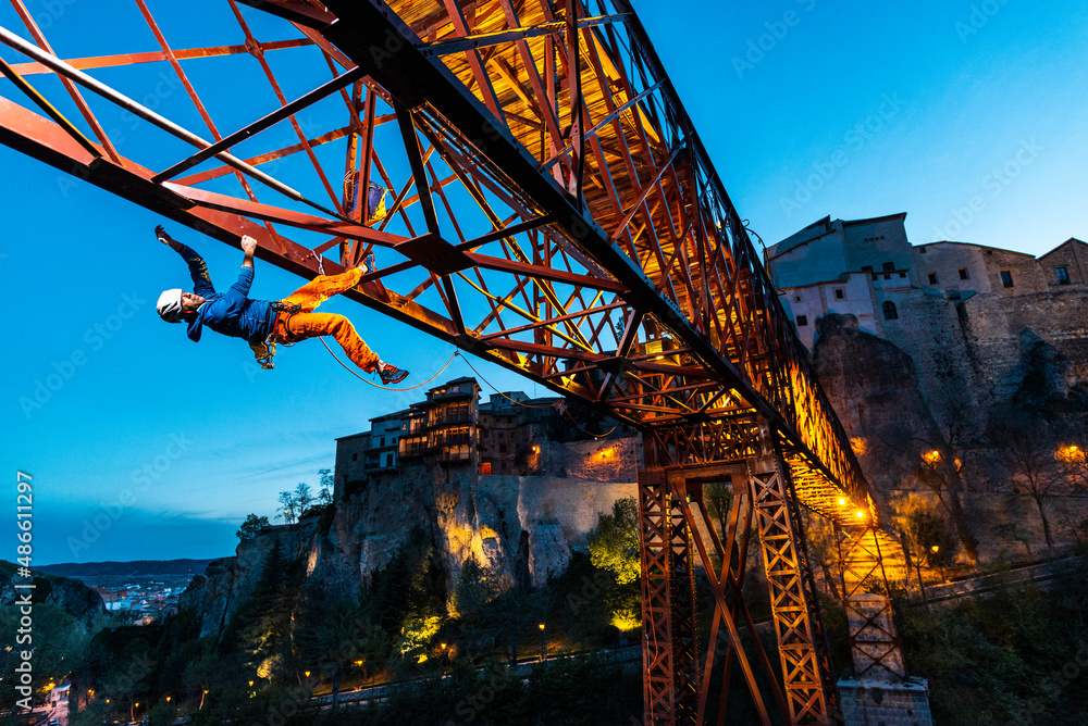 Authentic man rock climbing a metal bridge in the city Stock Photo ...