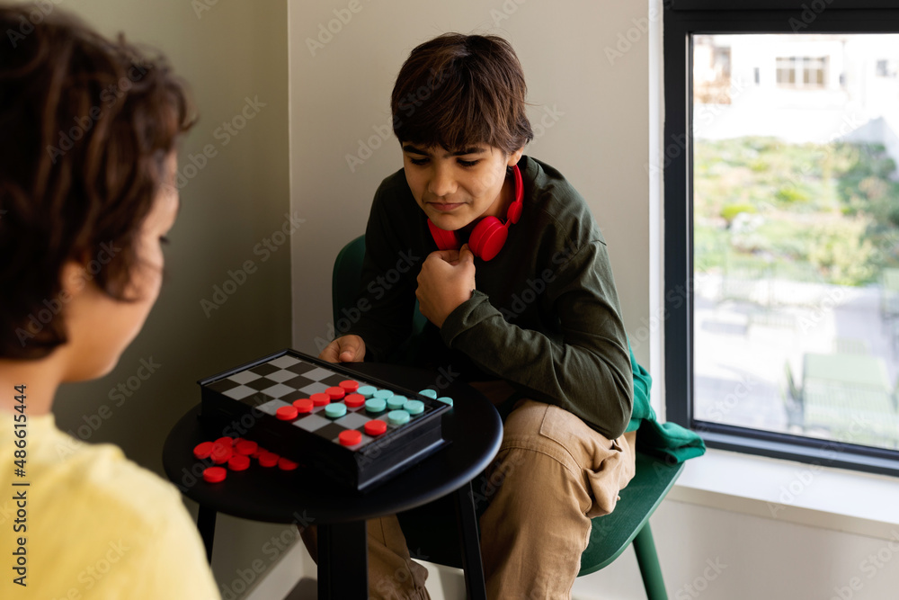 kids playing checkers on a playdate Stock Photo | Adobe Stock