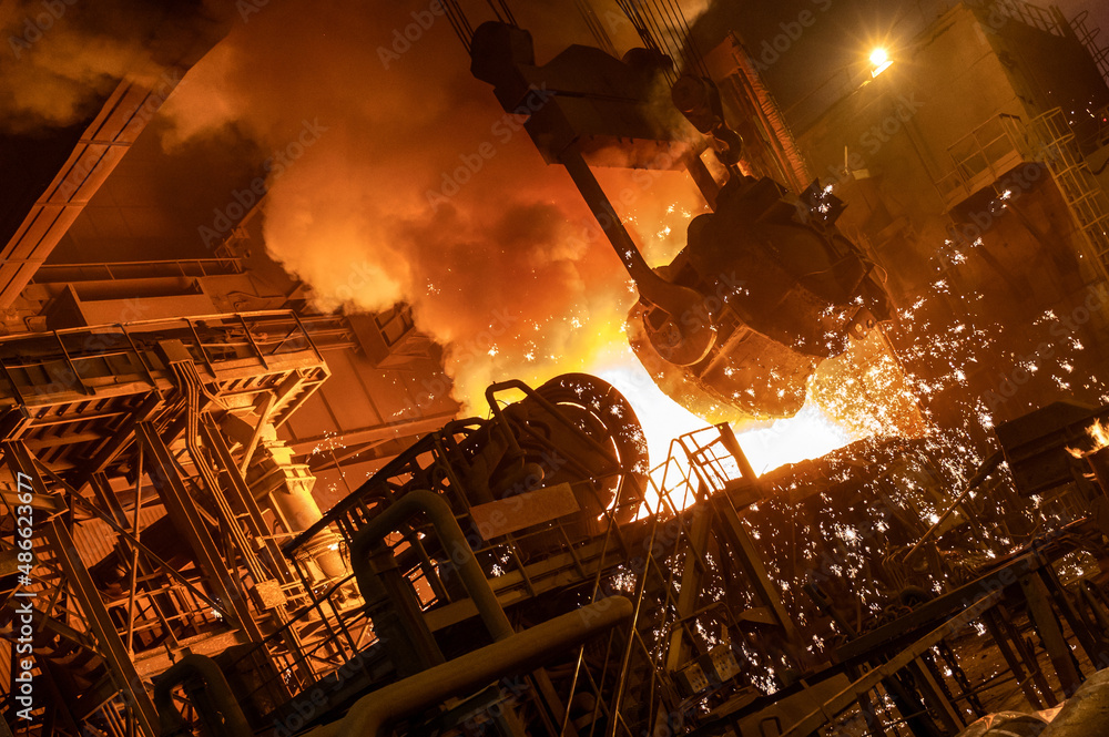 The process of pouring molten steel into a metallurgical furnace Stock ...