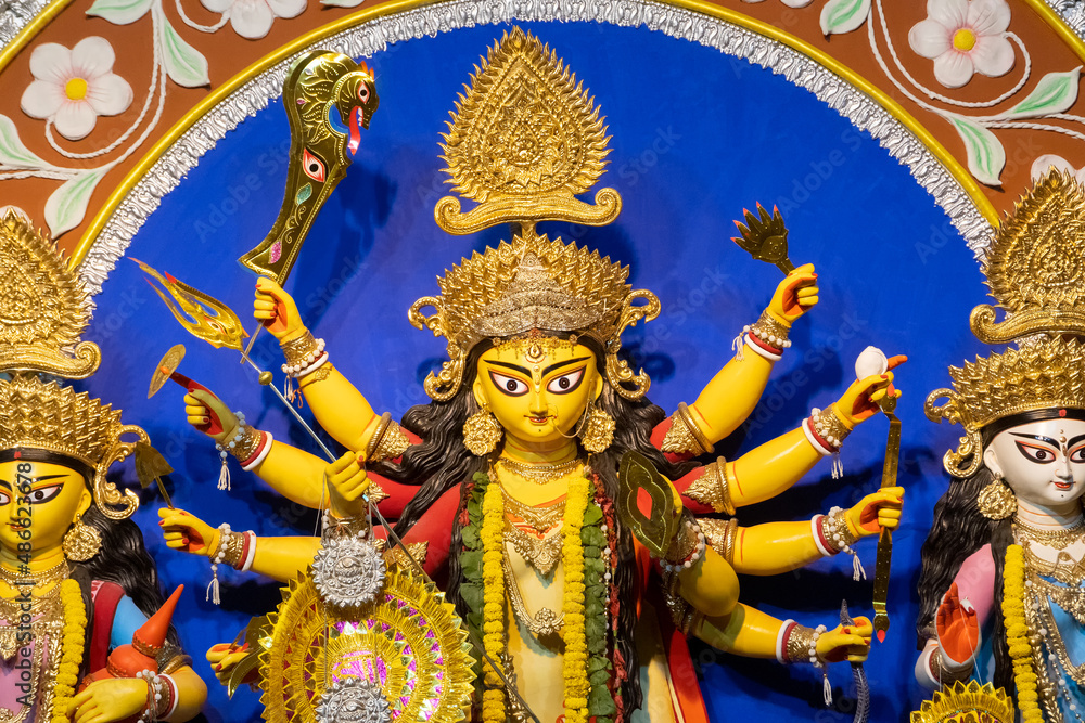 Goddess Durga idol at decorated Durga Puja pandal, shot at colored ...