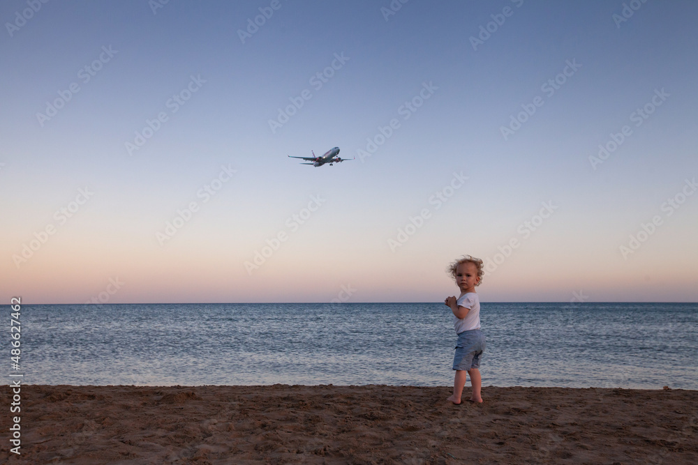 travel, cute child looking at airplane flying in sky Stock Photo ...