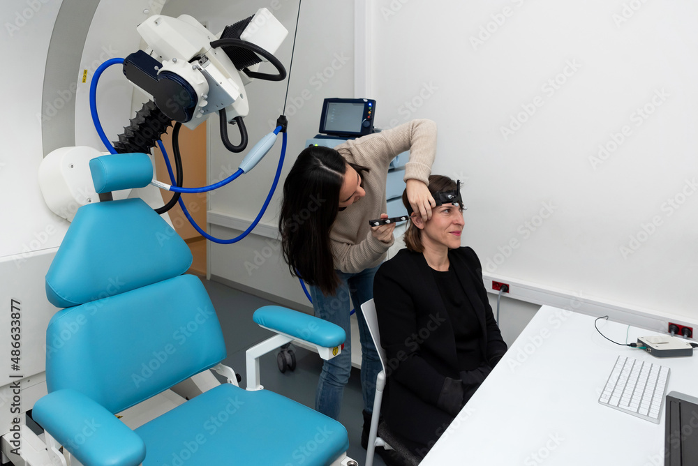 Doctor measuring brain of patient with TMS Stock Photo | Adobe Stock