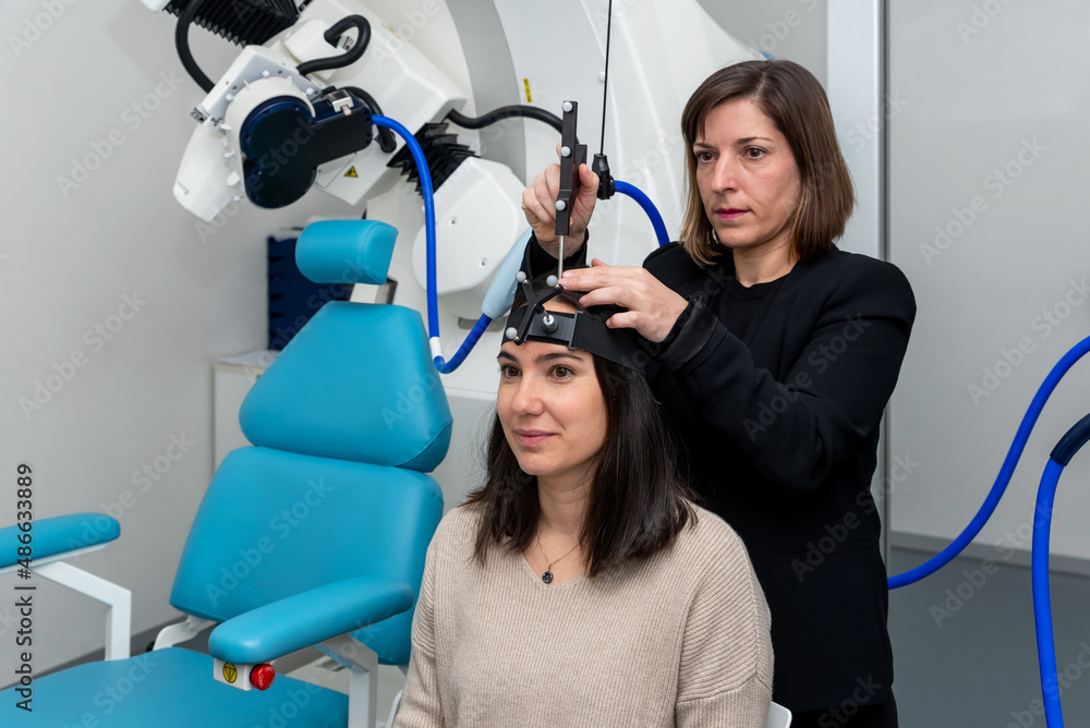 Doctor measuring brain of patient with TMS Stock Photo | Adobe Stock