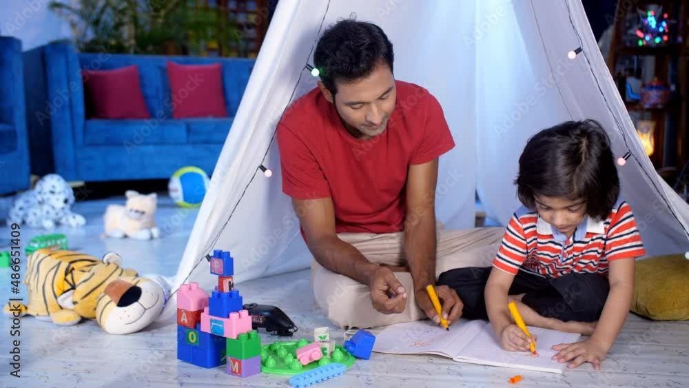 Sweet adorable boy with long hair and his young dad drawing a sketch ...