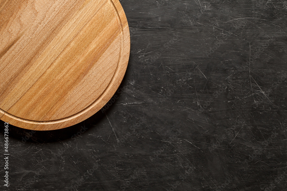 Pizza stand, round wooden, top view dark background, with space to copy ...