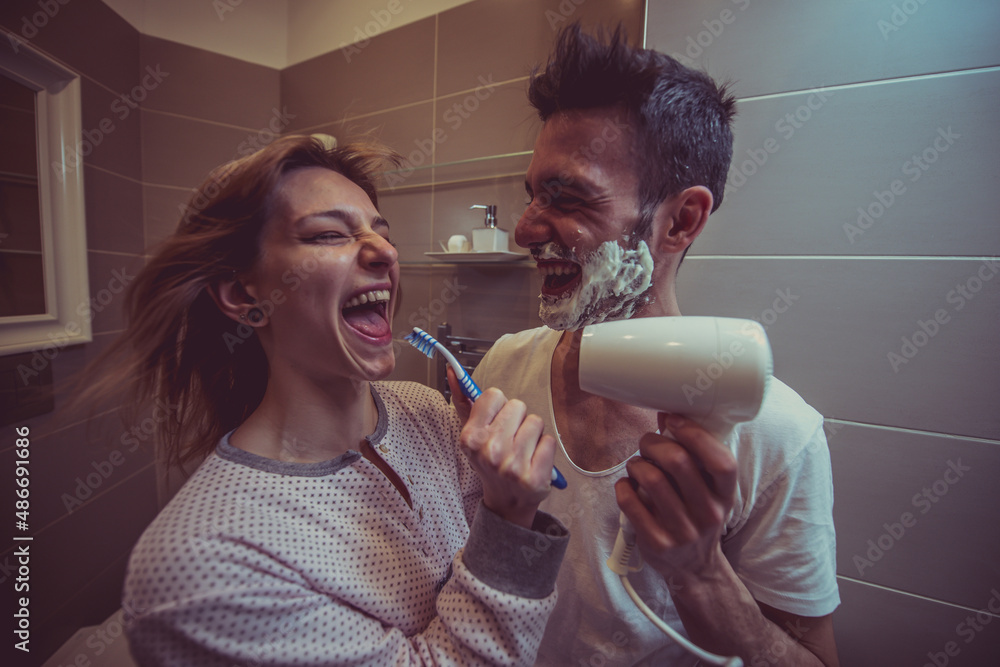 Couple morning routine. Man and woman sharing bathroom. Shaving beard ...