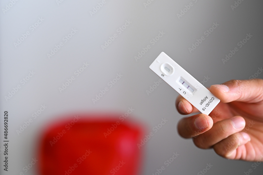 Man hand showing Covid-19 positive test result with SARS CoV-2 Rapid ...