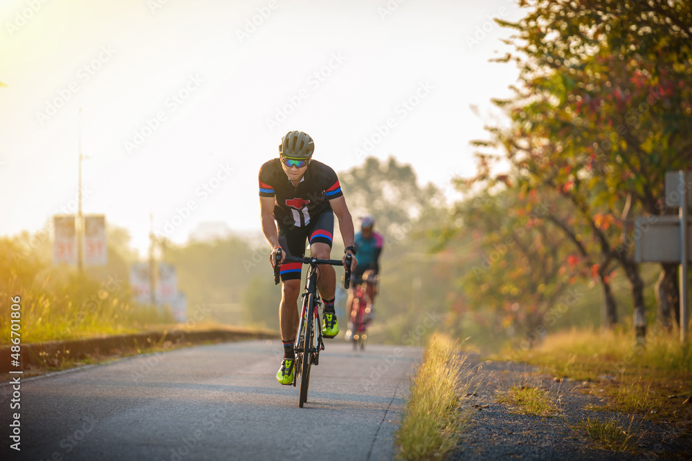 cyclist leads in action,Front view man riding bicycle in the racing ...