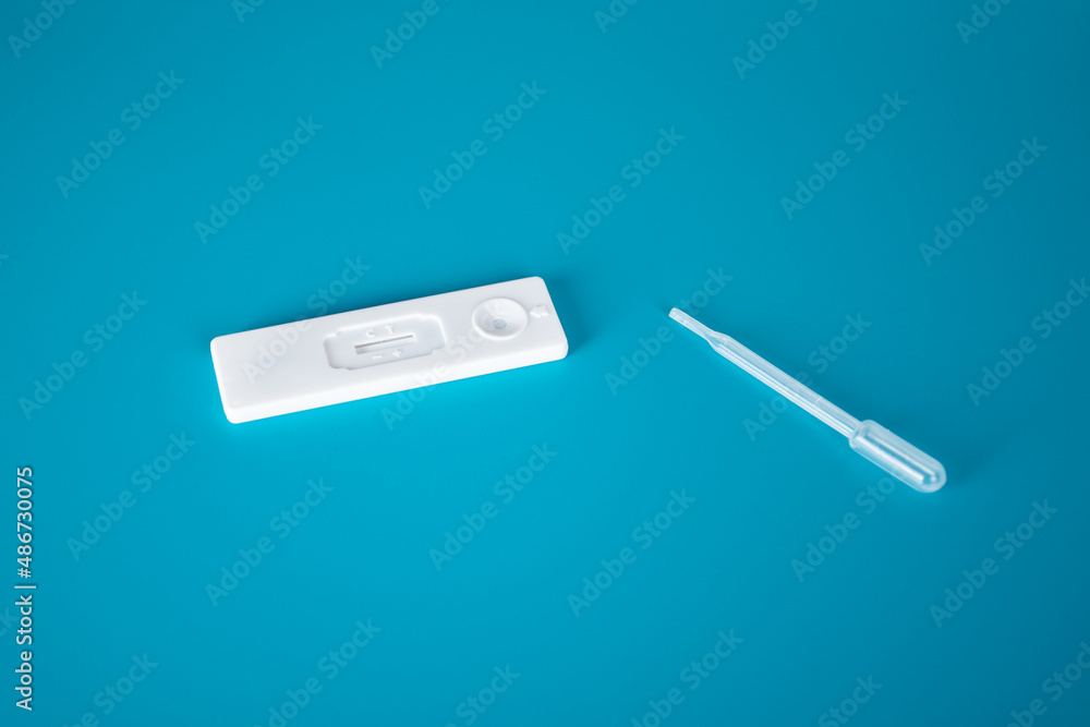 lateral flow test, blood cassette and pipette on blue medical ...