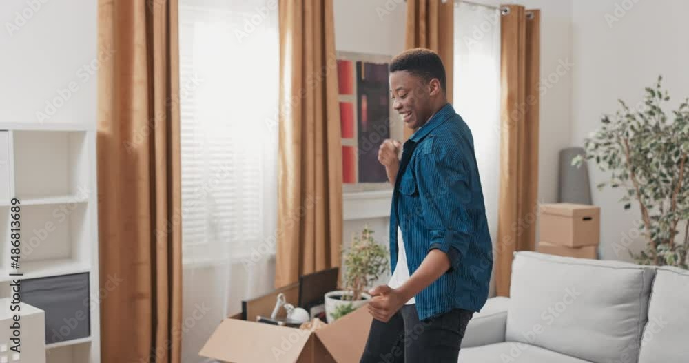 Man full of energy and optimism is dancing in middle of living room in ...