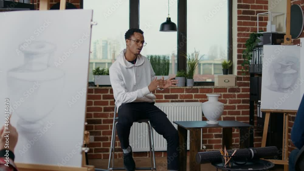 Creative man teaching artistic skills to students at workshop. Art ...