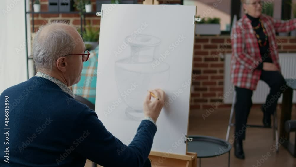 Senior man attending art class lesson to develop new skills, learnng ...